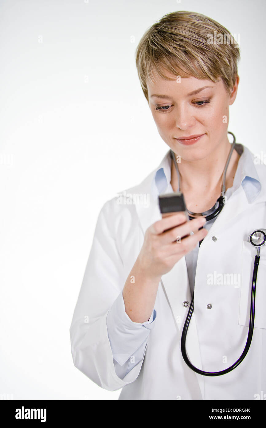 A female doctor using a mobile phone Stock Photo - Alamy