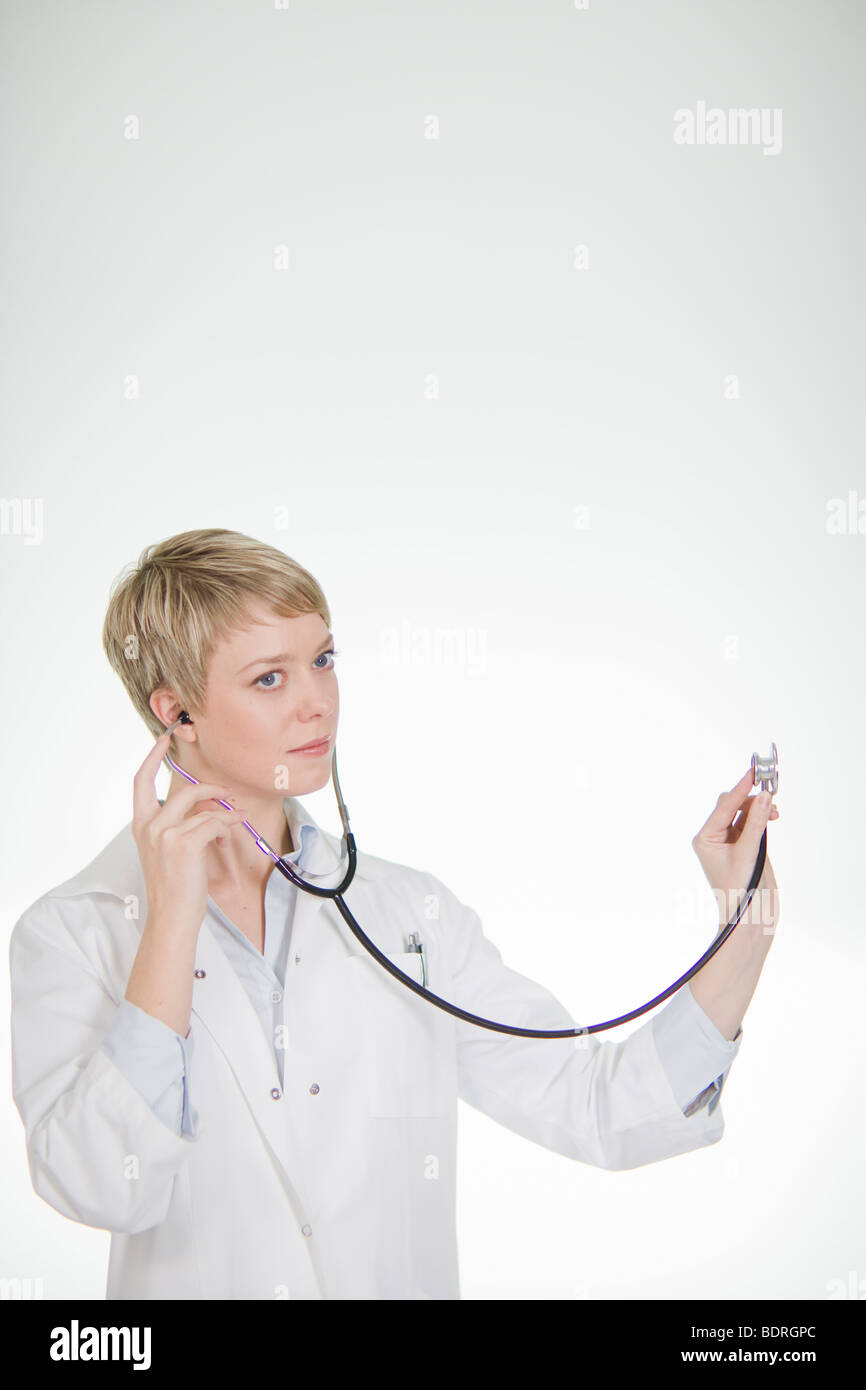A female doctor listening into a stethoscope Stock Photo - Alamy