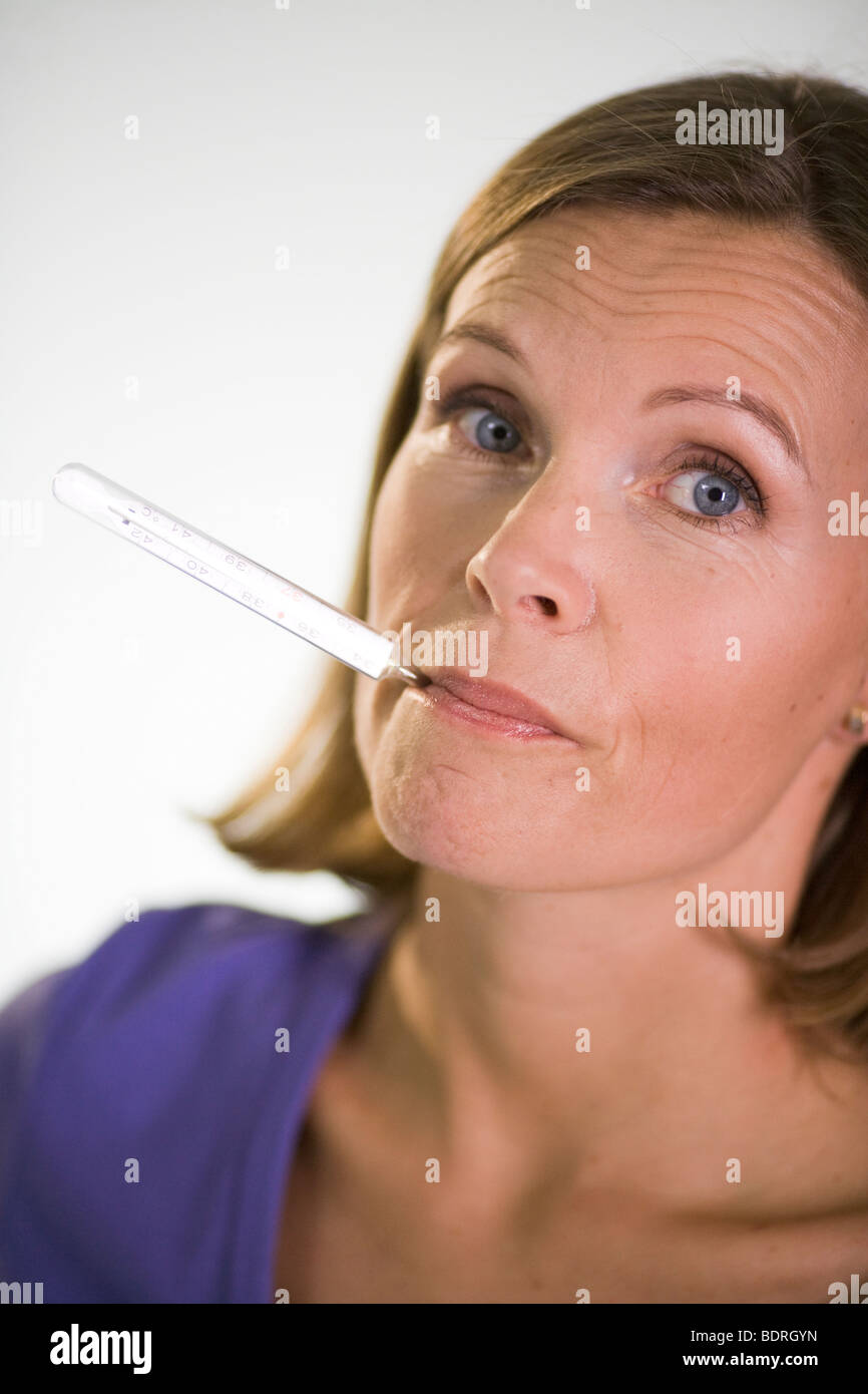 A woman taking her temperature Stock Photo - Alamy
