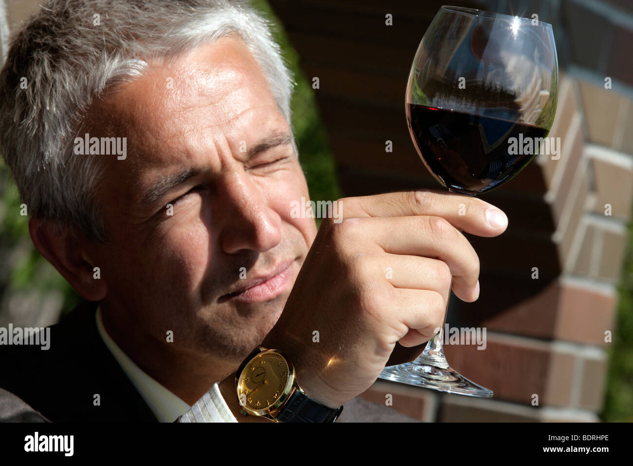 Portrait of man observing color in wine Stock Photo - Alamy