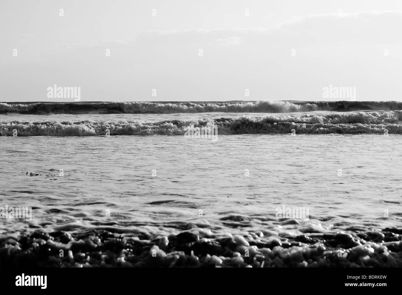Foaming beach waves Black and White Stock Photos & Images - Alamy