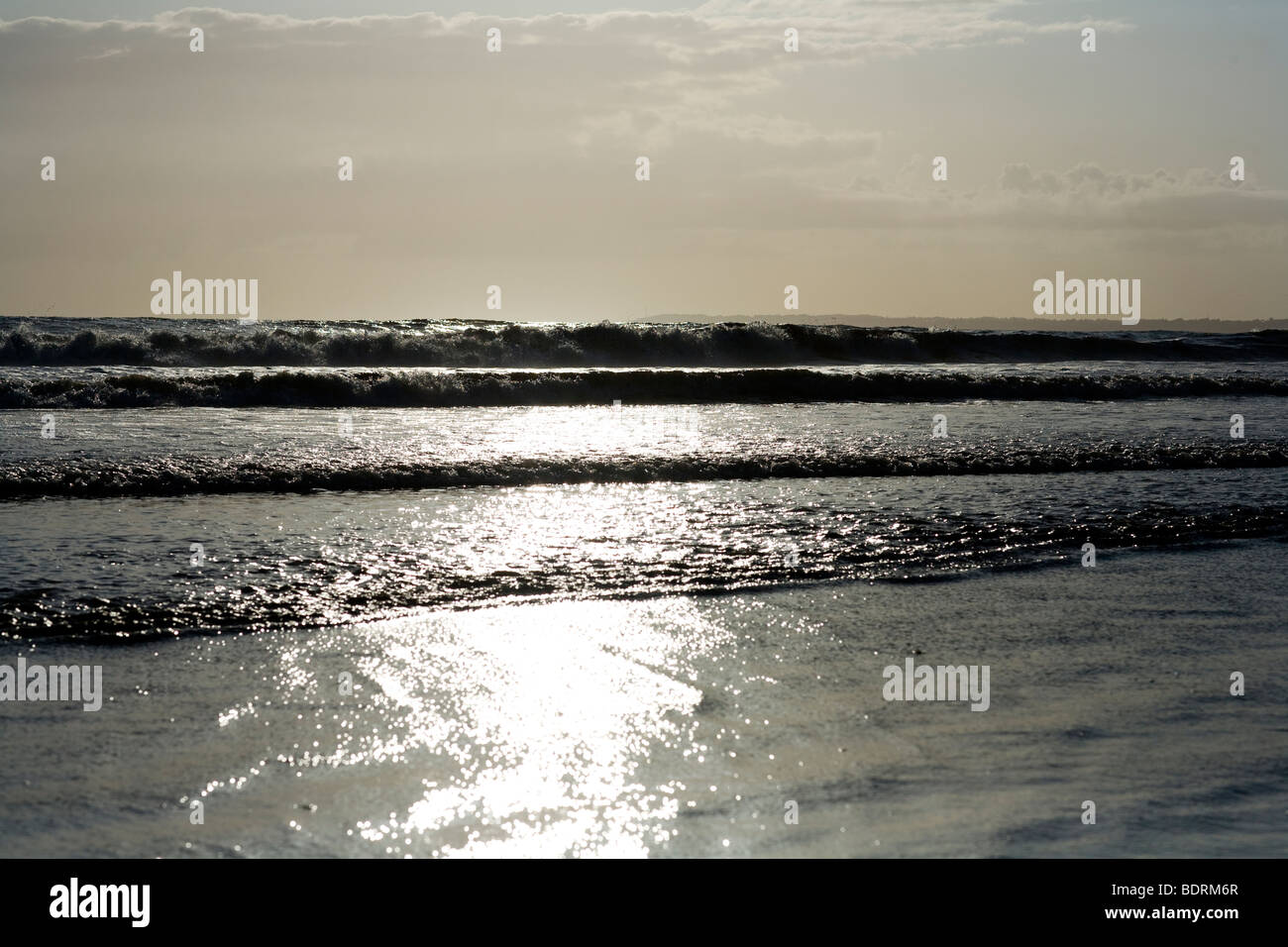 Waves crash on beach sunset hi-res stock photography and images - Alamy