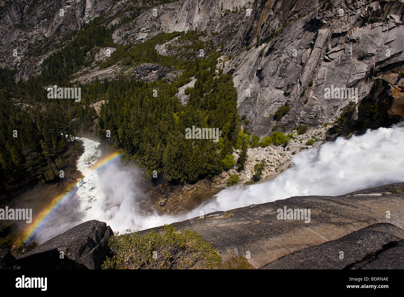 A rainbow appears over Nevada Falls in the mist. Yosemite National Park ...