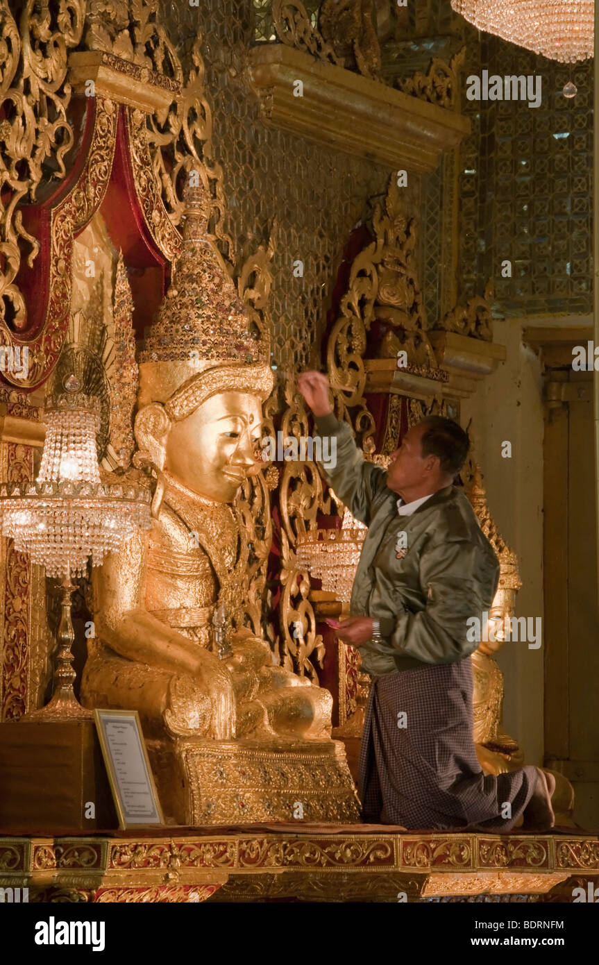 Member of the ruling military offers gold as gilding, as traditional ...