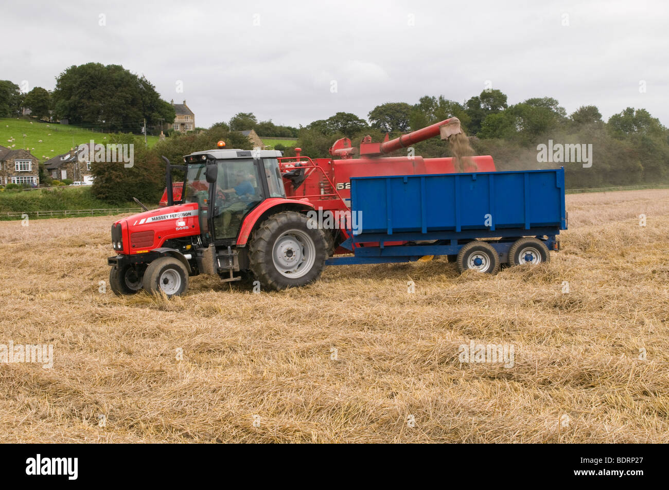 Tractor harvests the crop Stock Photo - Alamy