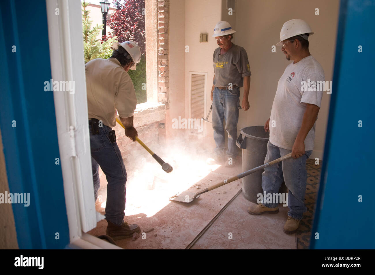 Construction workers breaking wall with sledgehammer Stock Photo - Alamy