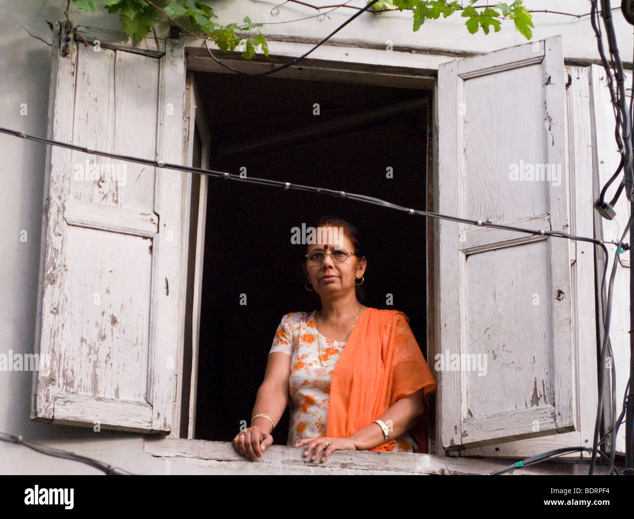 Indian woman looking outside window hi-res stock photography and images ...