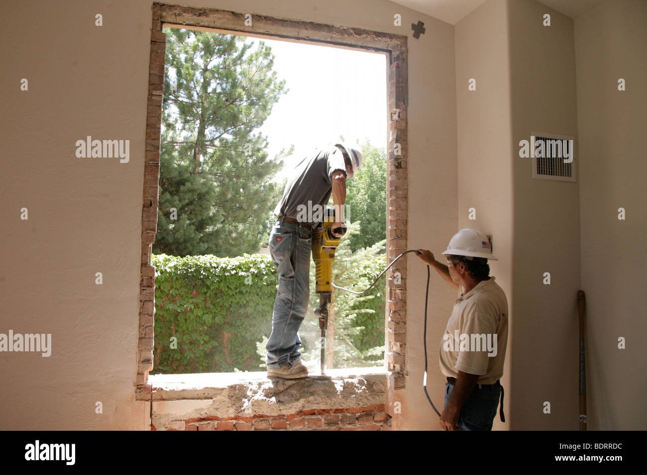 Construction workers drilling at construction site Stock Photo - Alamy
