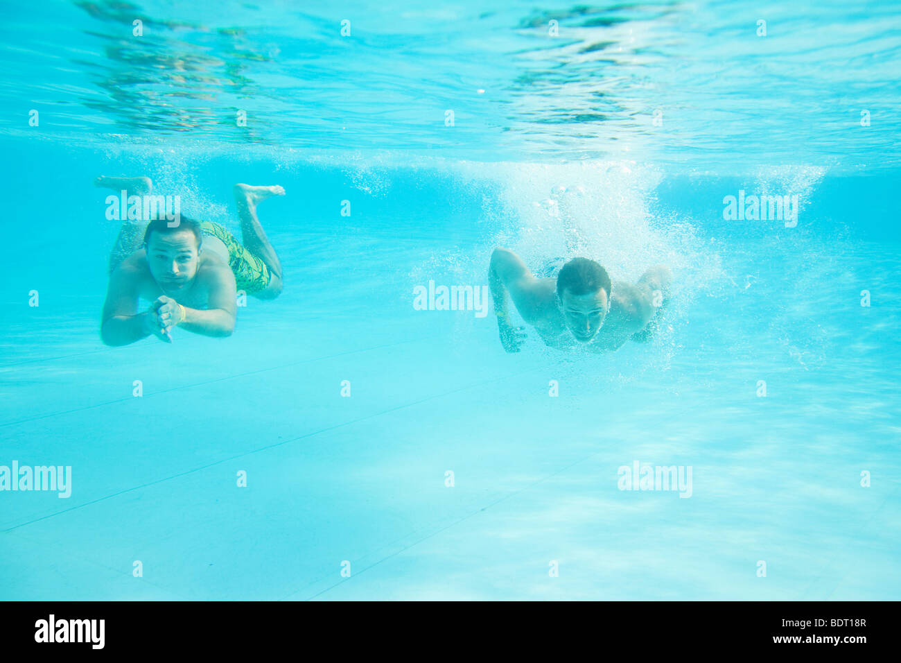 Friends swimming underwater together hi-res stock photography and ...