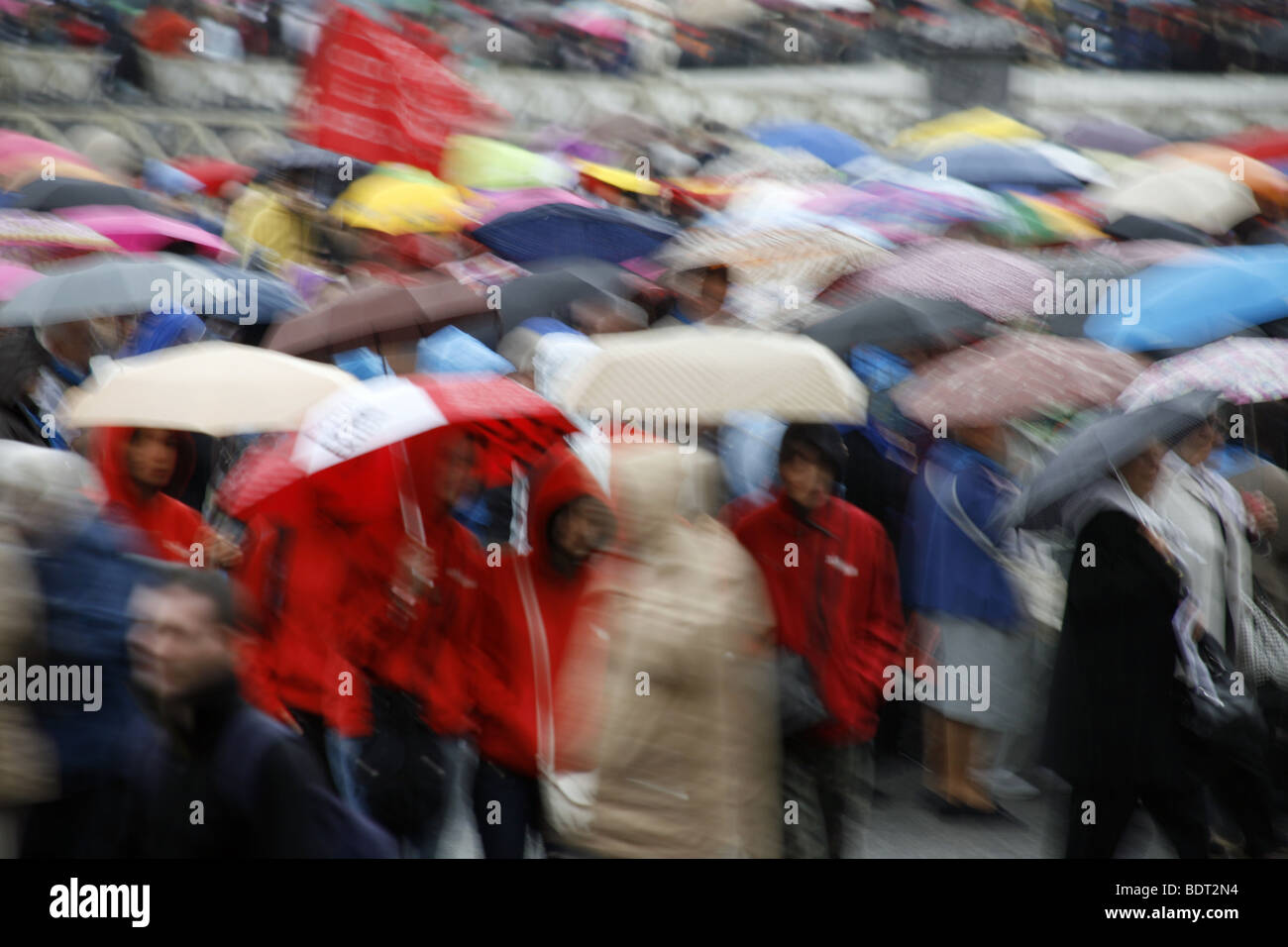 crowd of people with umbrellas in heavy rain in city town Stock Photo ...