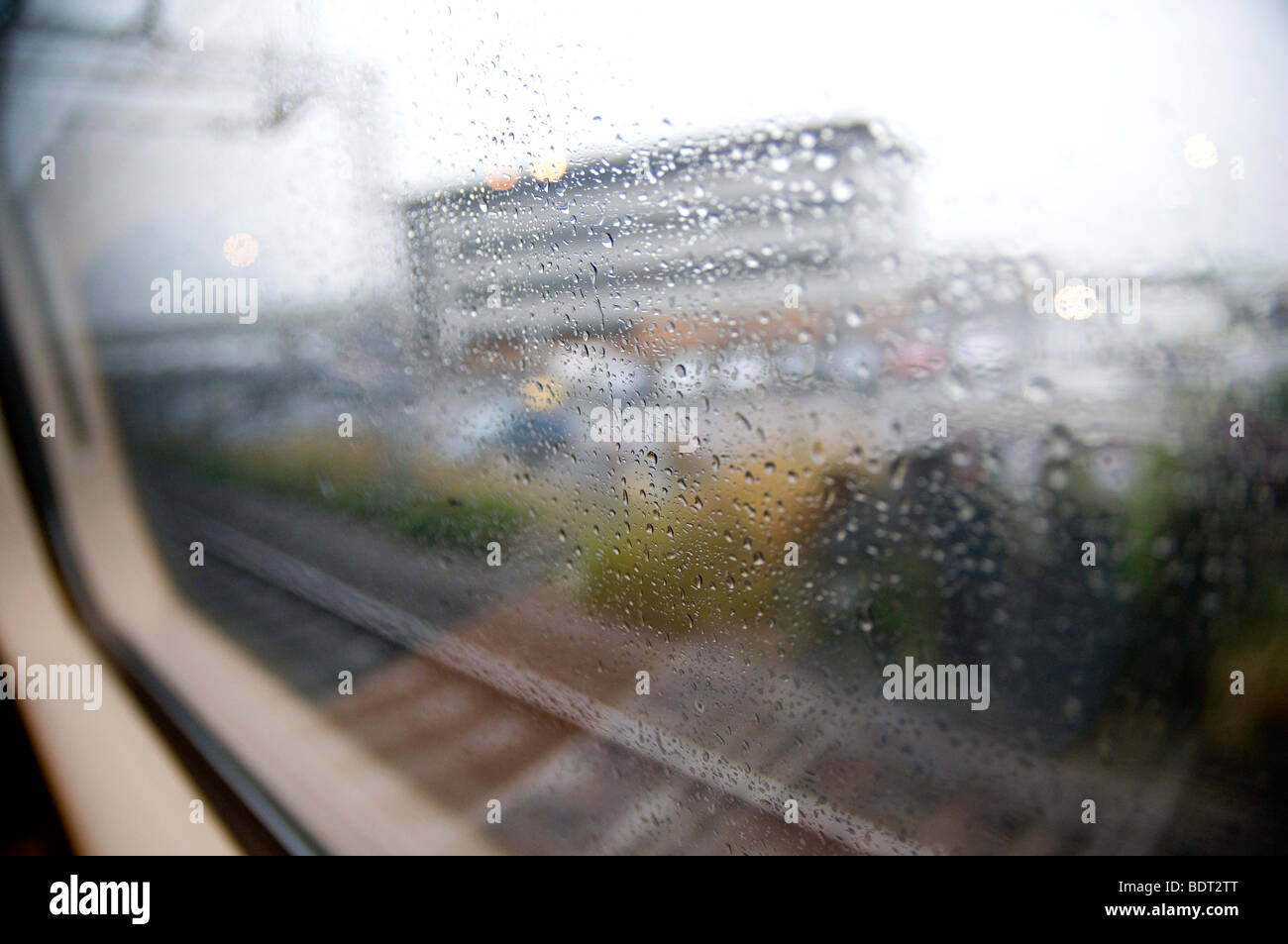 urban rail journey looking out of a rain covered window in Birmingham ...