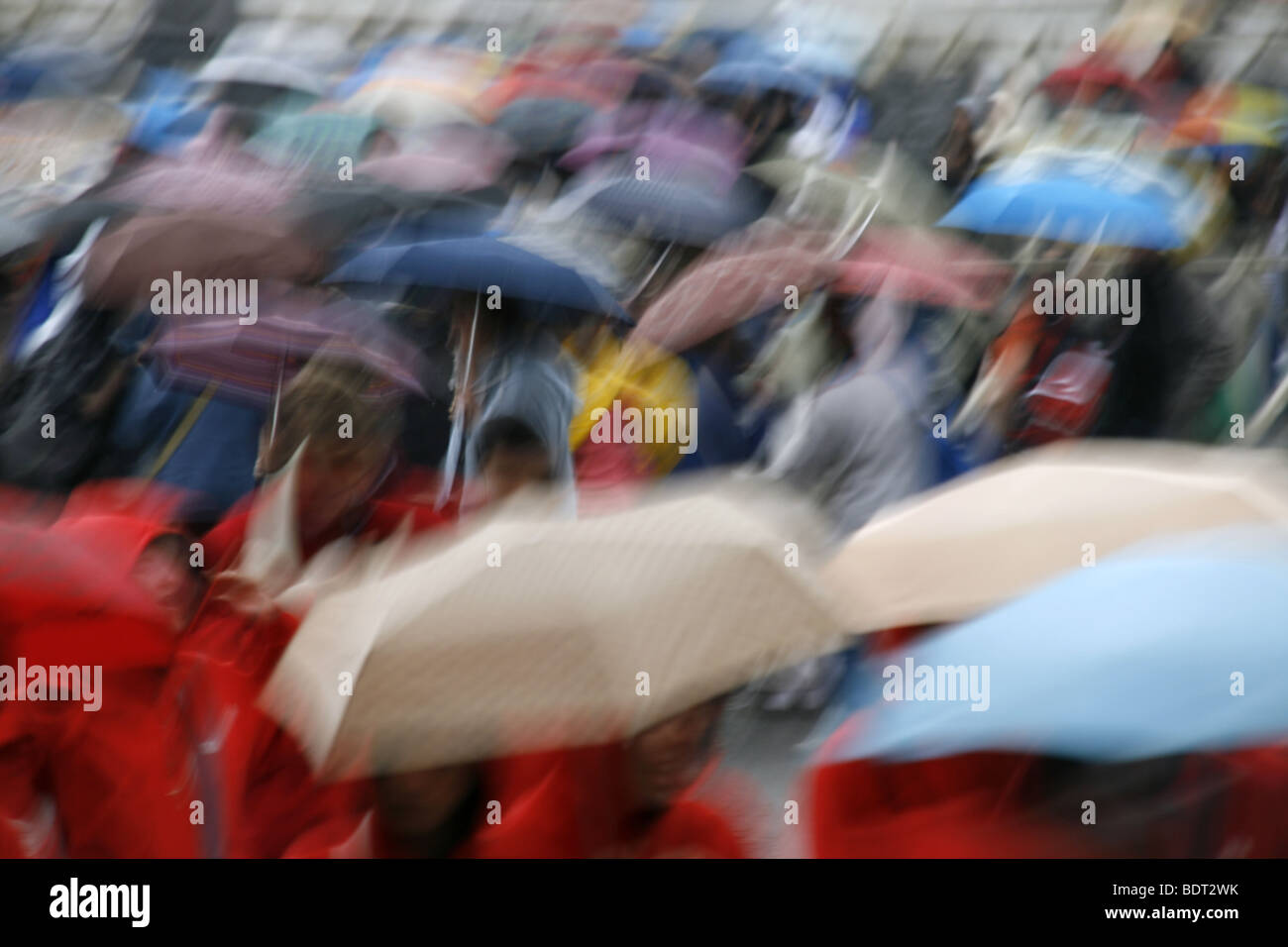crowd of people with umbrellas in heavy rain in city town Stock Photo ...