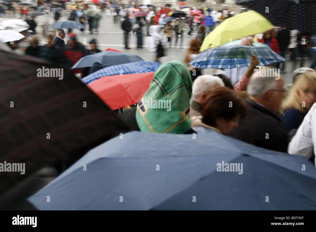 crowd of people with umbrellas in heavy rain in city town Stock Photo ...