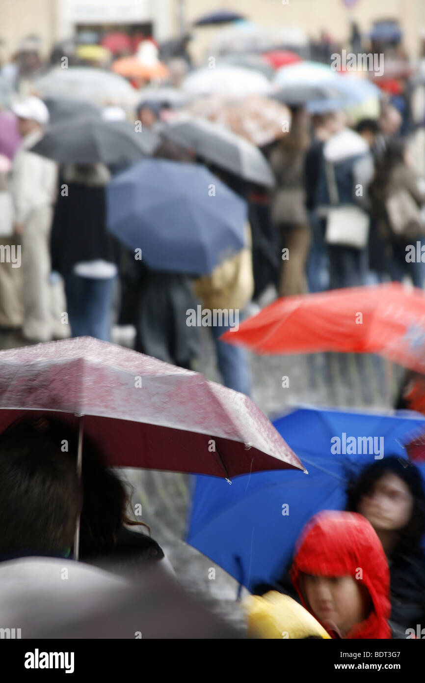 crowd of people with umbrellas in heavy rain in city town Stock Photo ...