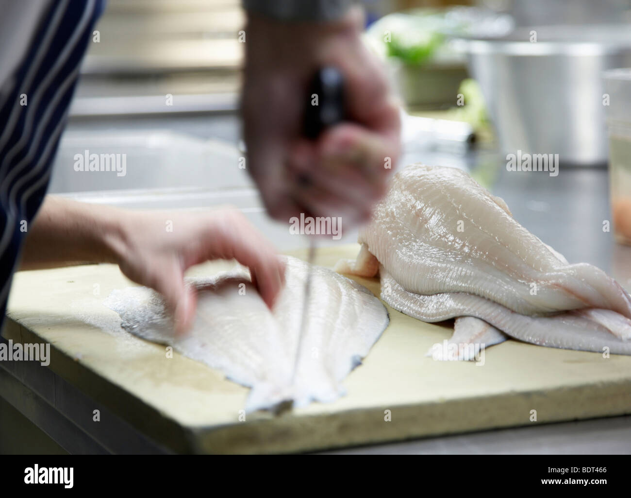 fish being sliced in kitchen by professional chef Stock Photo - Alamy