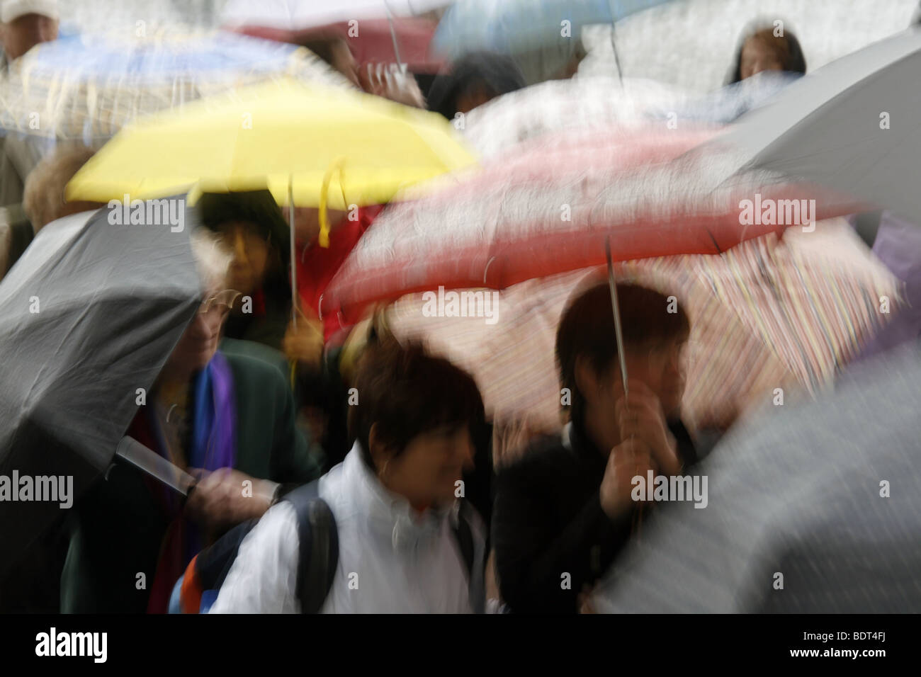 crowd of people with umbrellas in heavy rain in city town Stock Photo ...