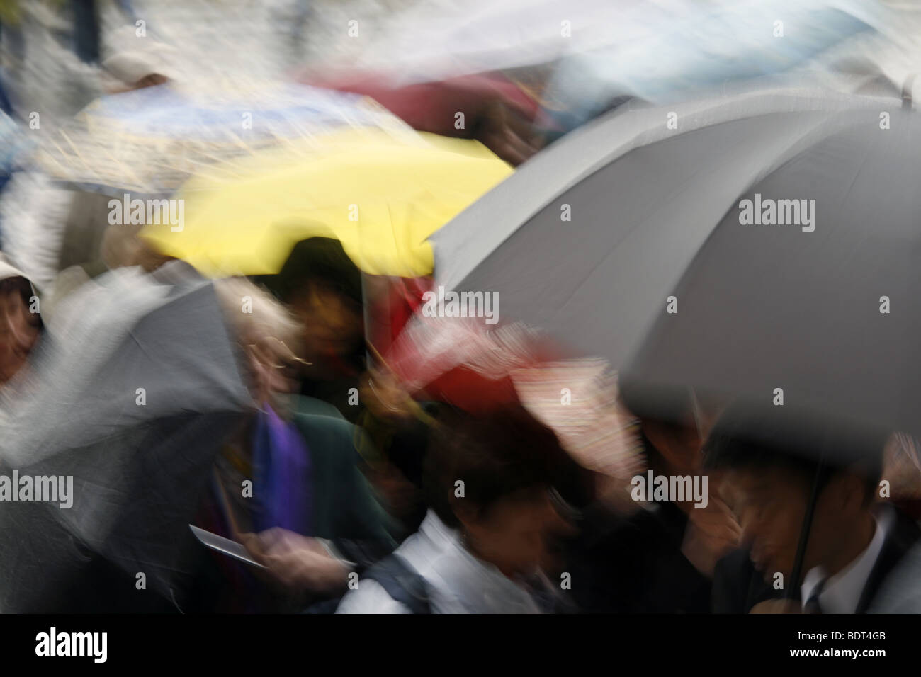 crowd of people with umbrellas in heavy rain in city town Stock Photo ...