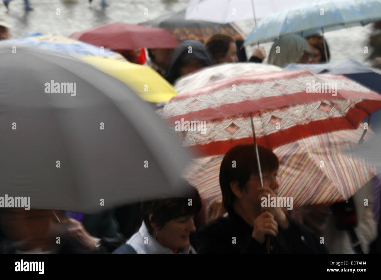 crowd of people with umbrellas in heavy rain in city town Stock Photo ...