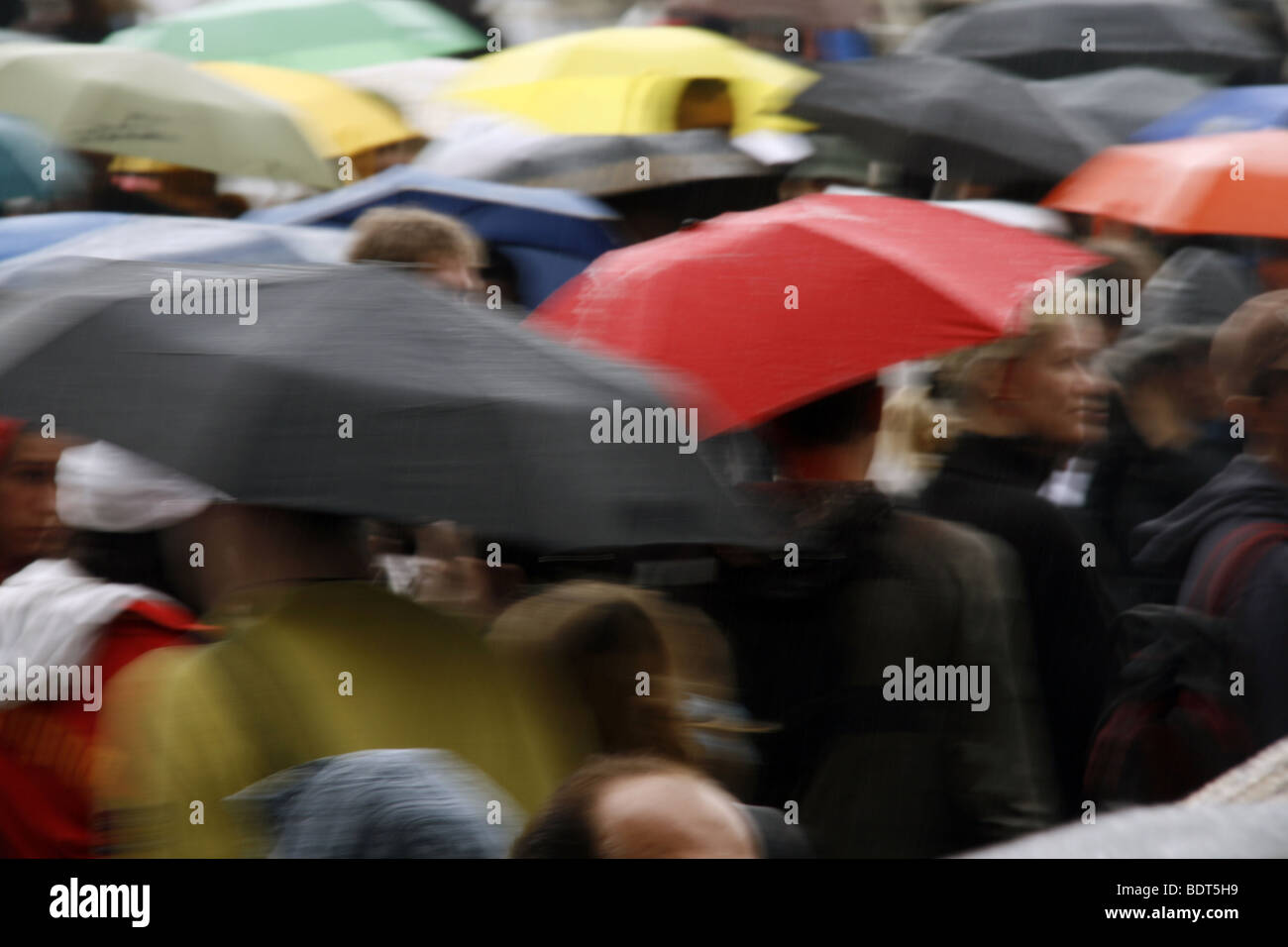 crowd of people with umbrellas in heavy rain in city town Stock Photo ...