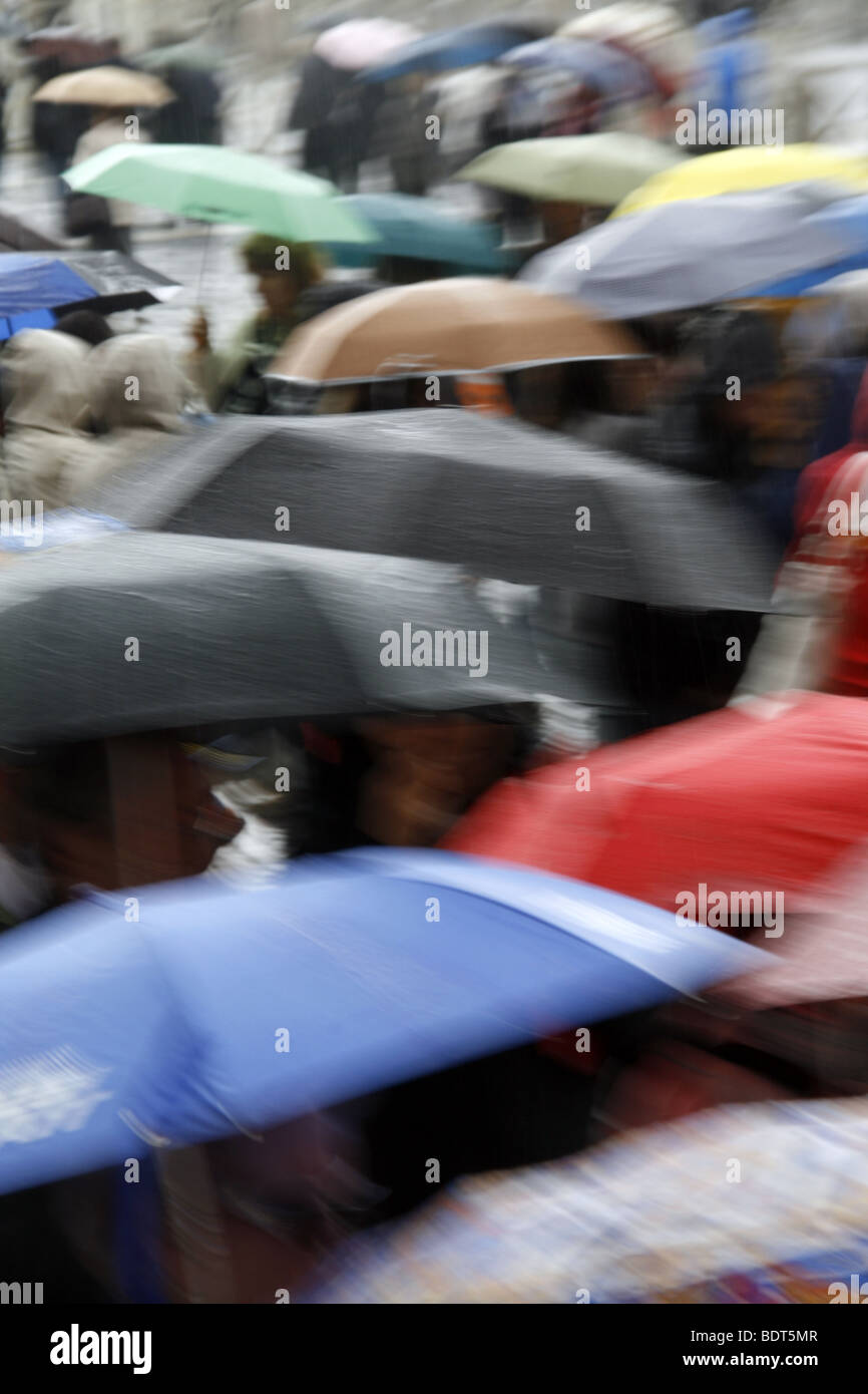 crowd of people with umbrellas in heavy rain in city town Stock Photo ...