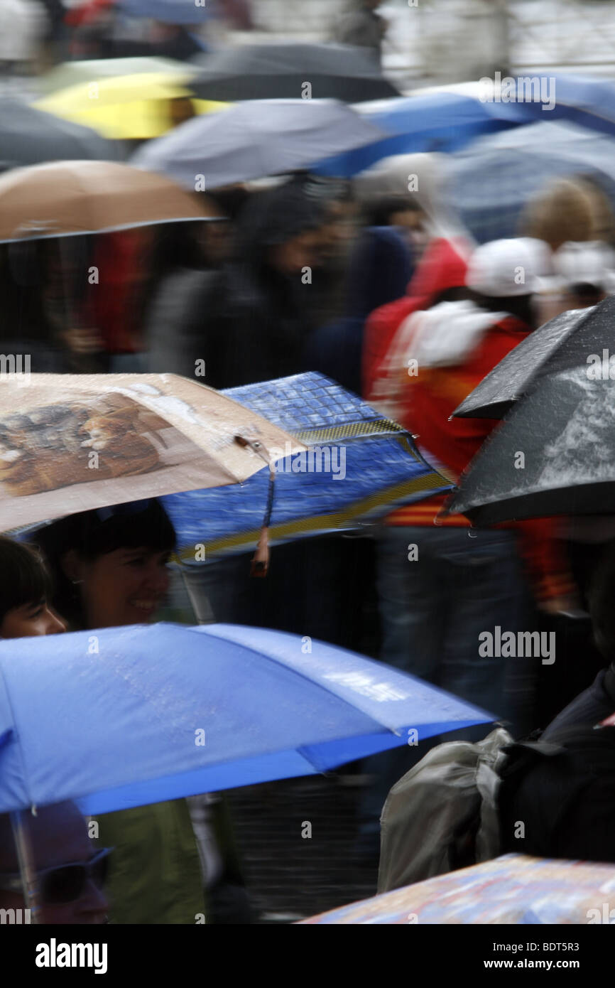 crowd of people with umbrellas in heavy rain in city town Stock Photo ...