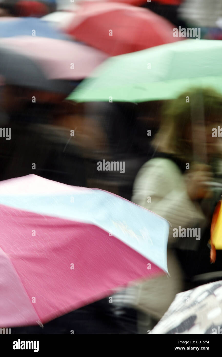 crowd of people with umbrellas in heavy rain in city town Stock Photo ...