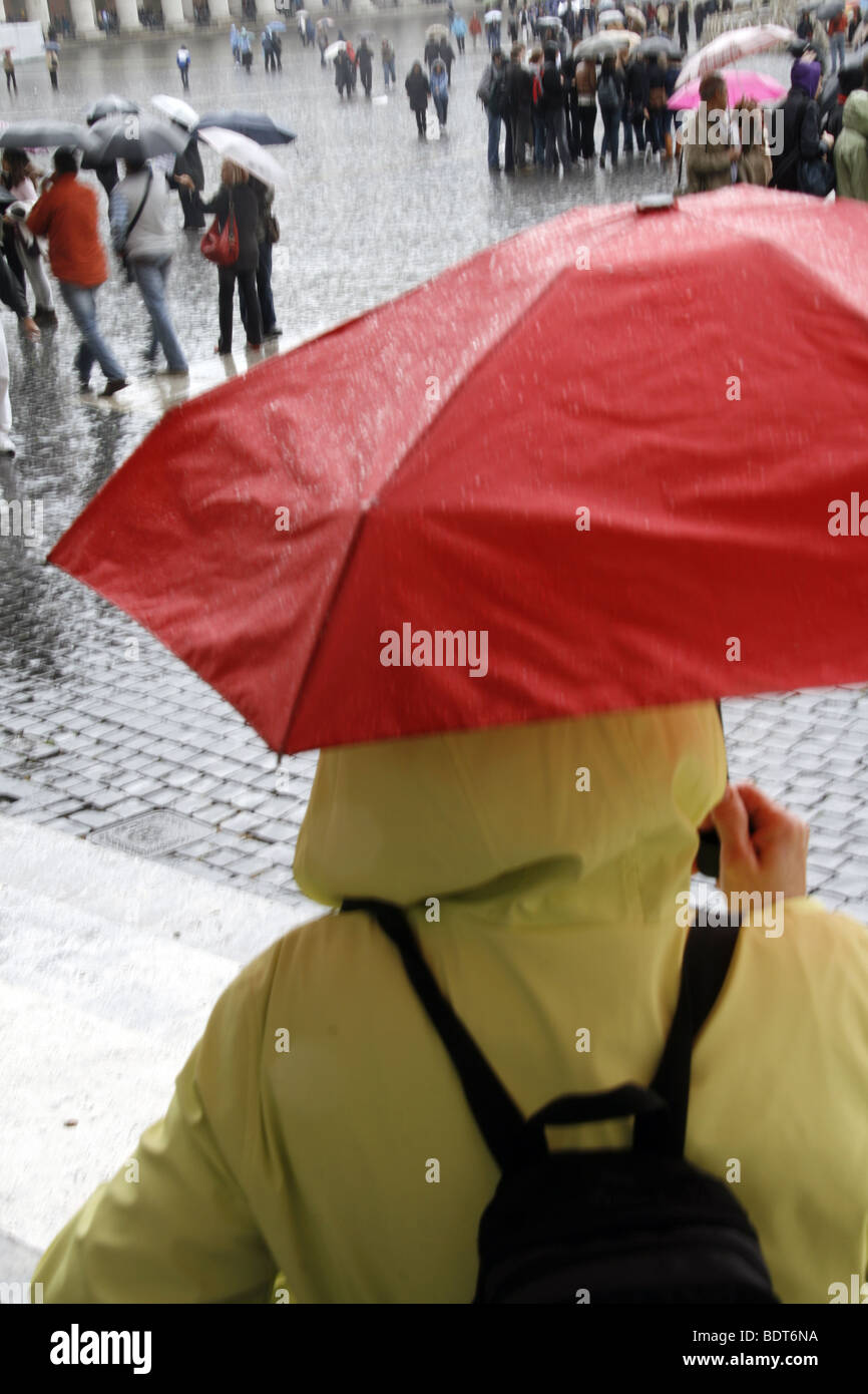 person with red umbrella in rain in city town Stock Photo - Alamy