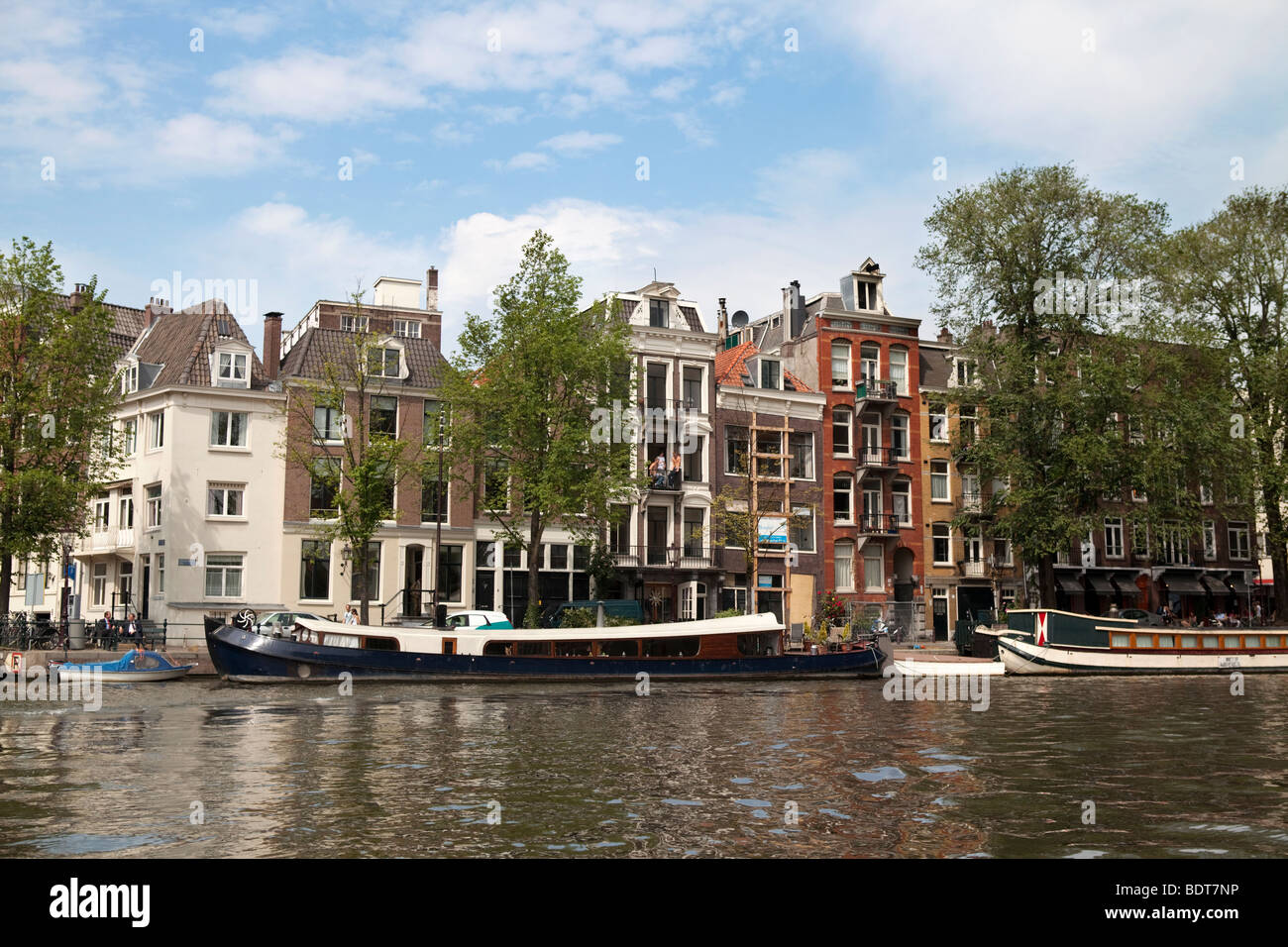 Amsterdam: waterfront buildings and house-boats on the canal. THe ...