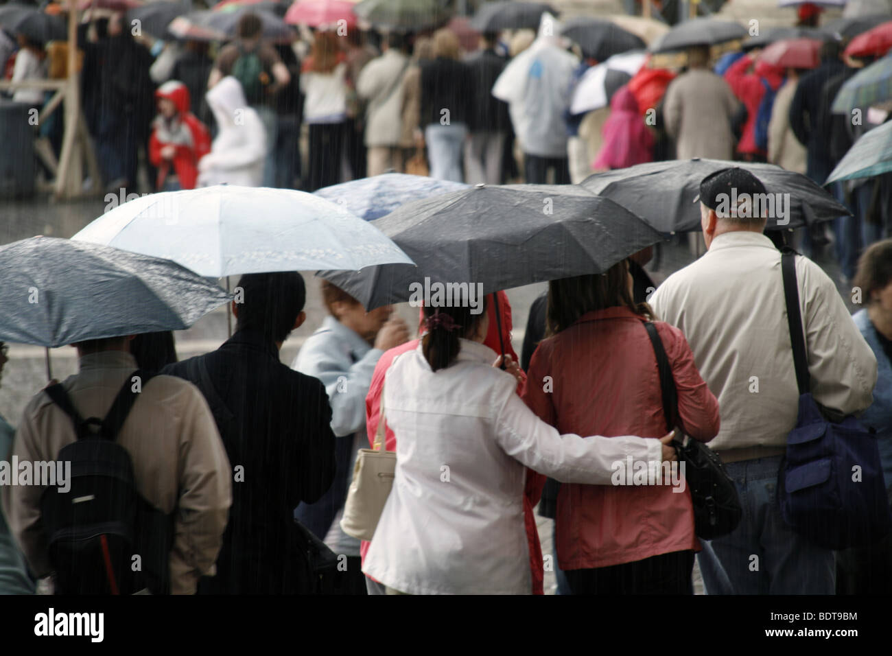 crowd of people with umbrellas in heavy rain in city town Stock Photo ...