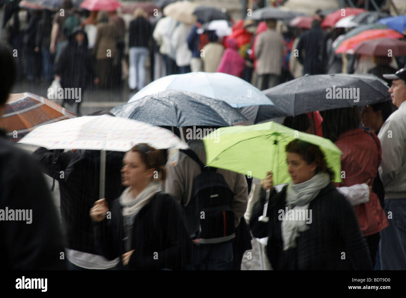 crowd of people with umbrellas in heavy rain in city town Stock Photo ...