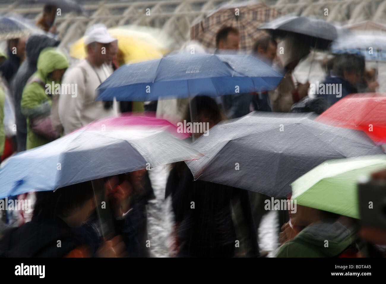 crowd of people with umbrellas in heavy rain in city town Stock Photo ...