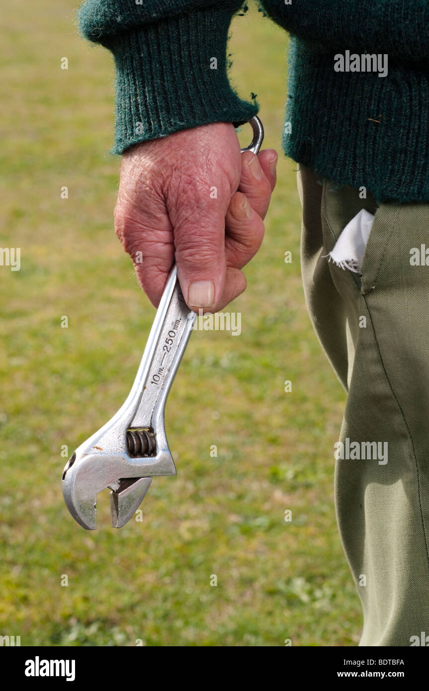 senior man holding spanner Stock Photo - Alamy