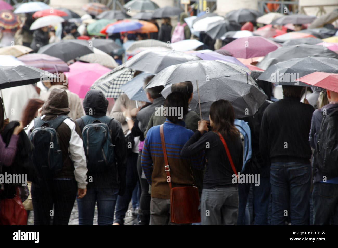 crowd of people with umbrellas in heavy rain in city town Stock Photo ...