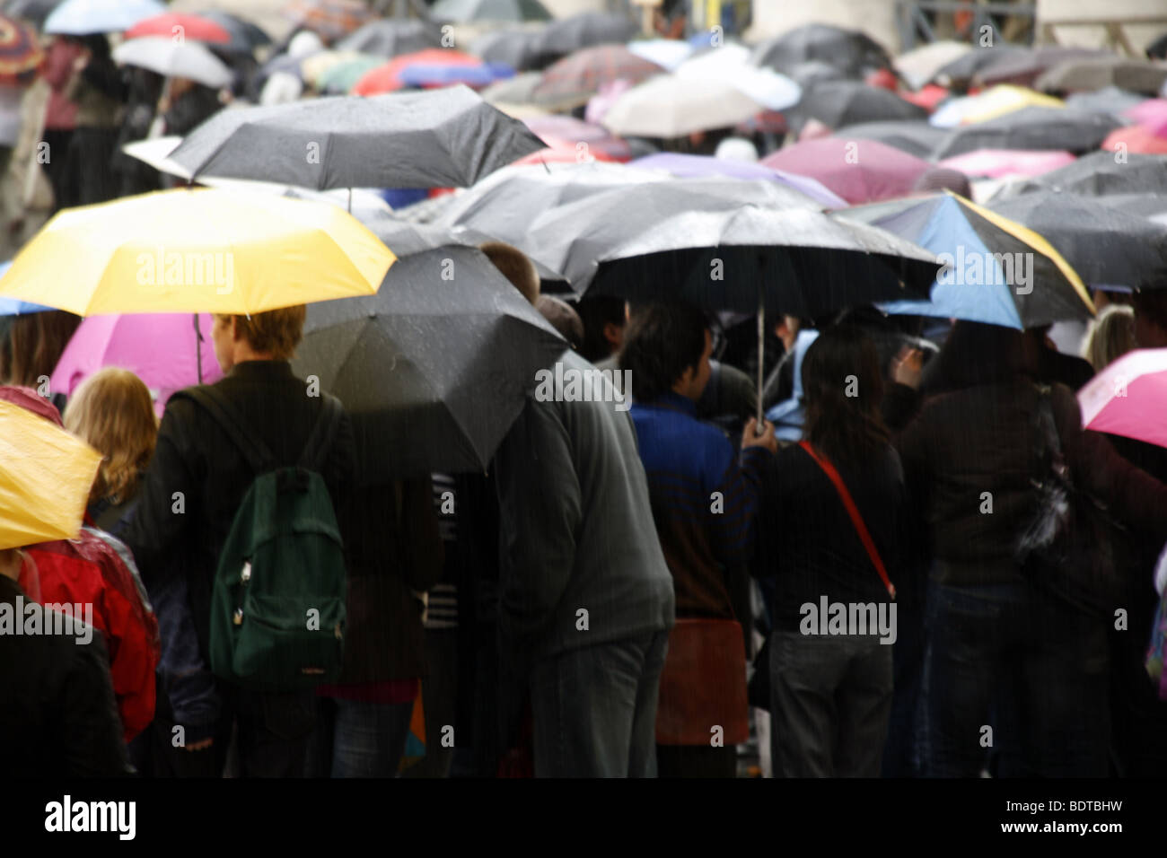 crowd of people with umbrellas in heavy rain in city town Stock Photo ...
