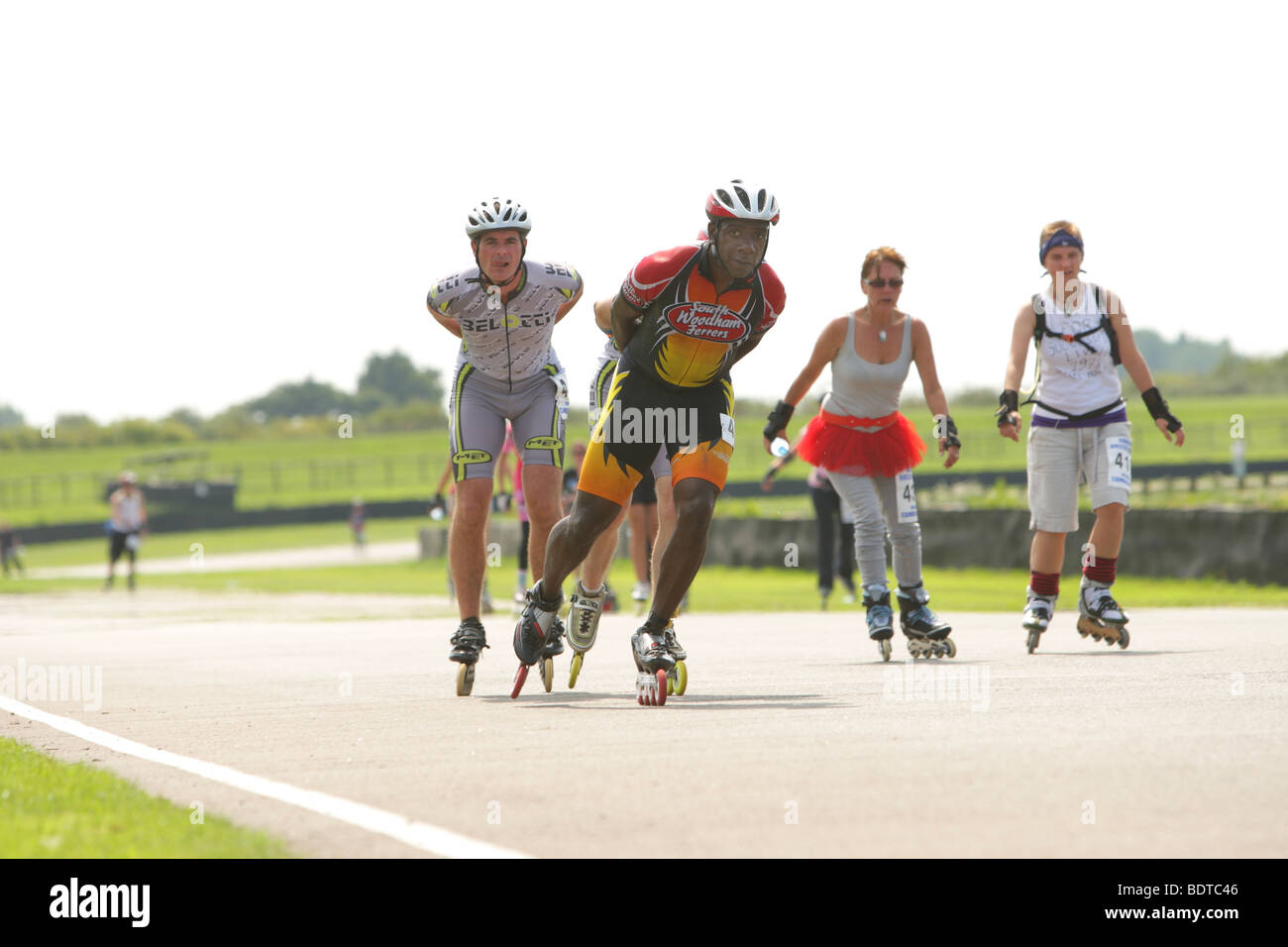Two speed skaters racing in a charity marathon Stock Photo - Alamy