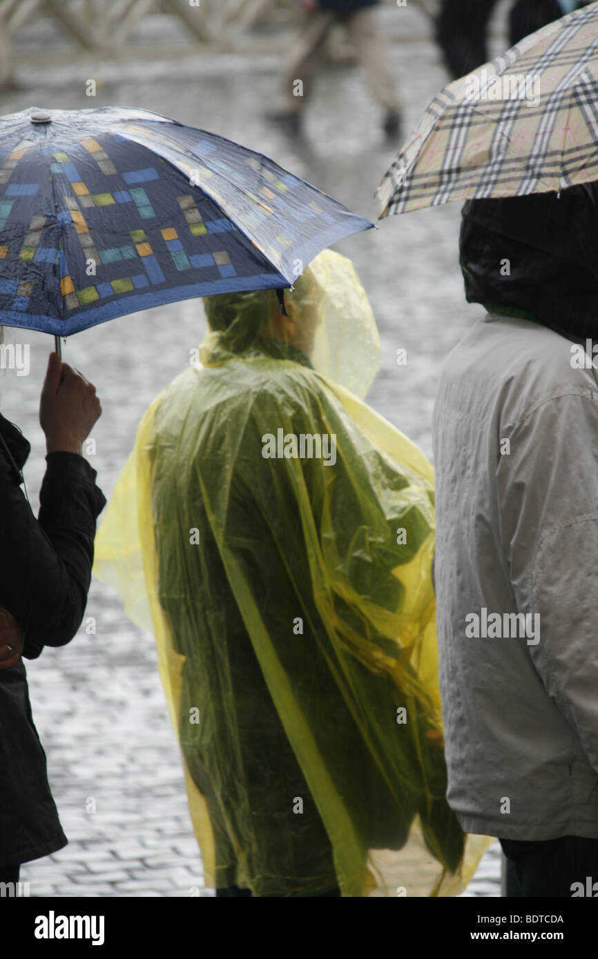 people with umbrellas in heavy rain in city town Stock Photo - Alamy