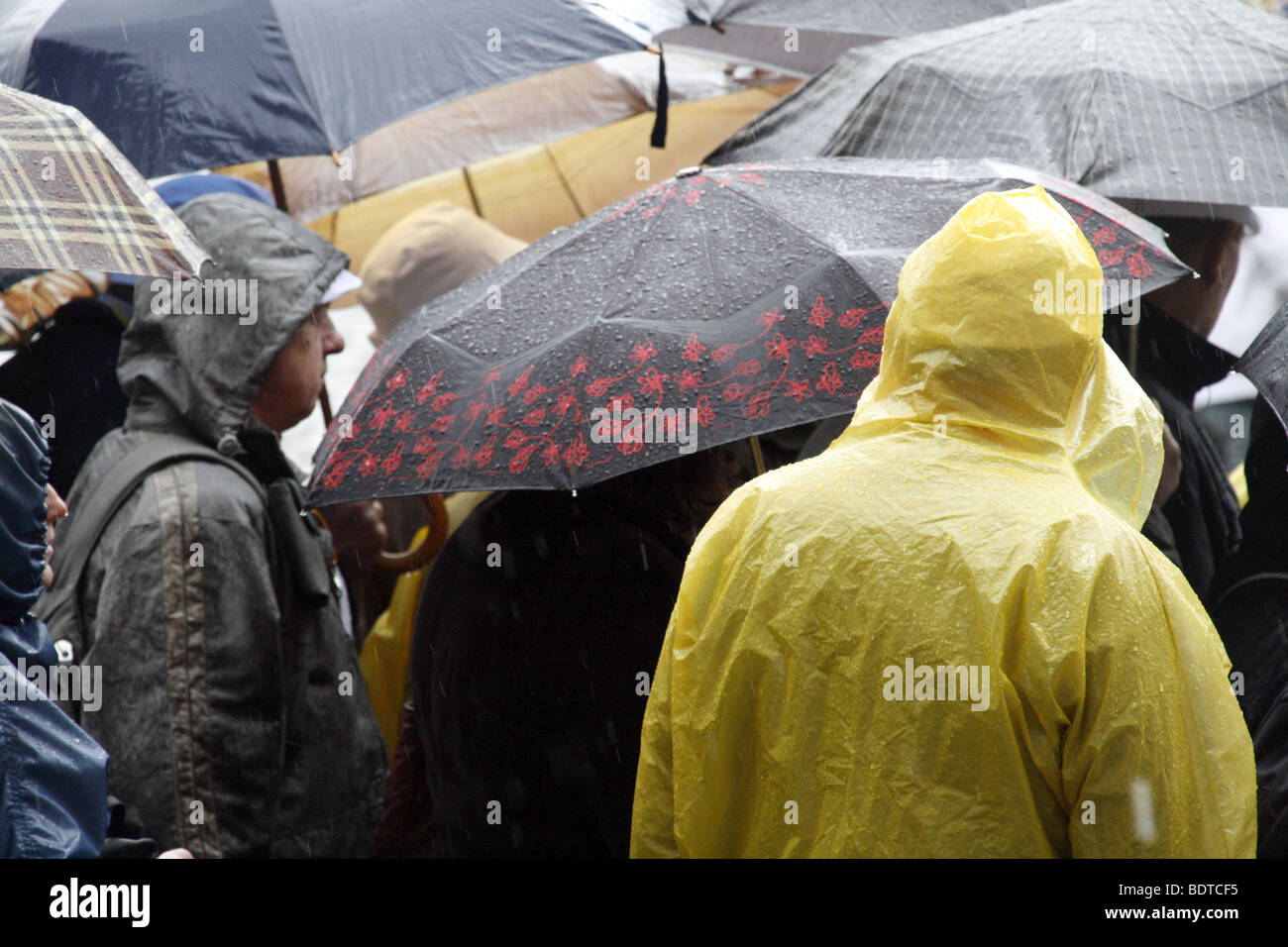 people with umbrellas in heavy rain in city town Stock Photo - Alamy