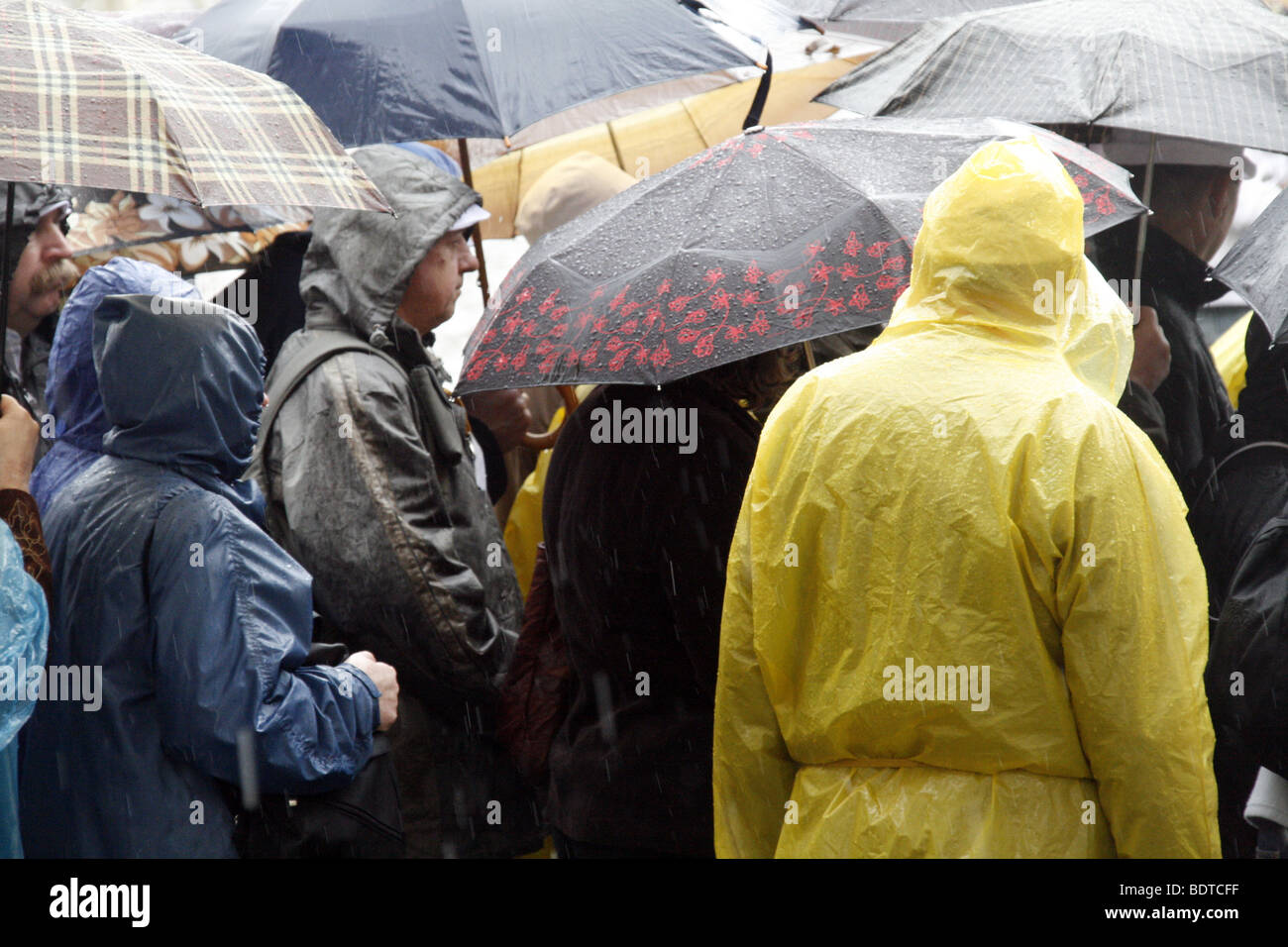 people with umbrellas in heavy rain in city town Stock Photo - Alamy