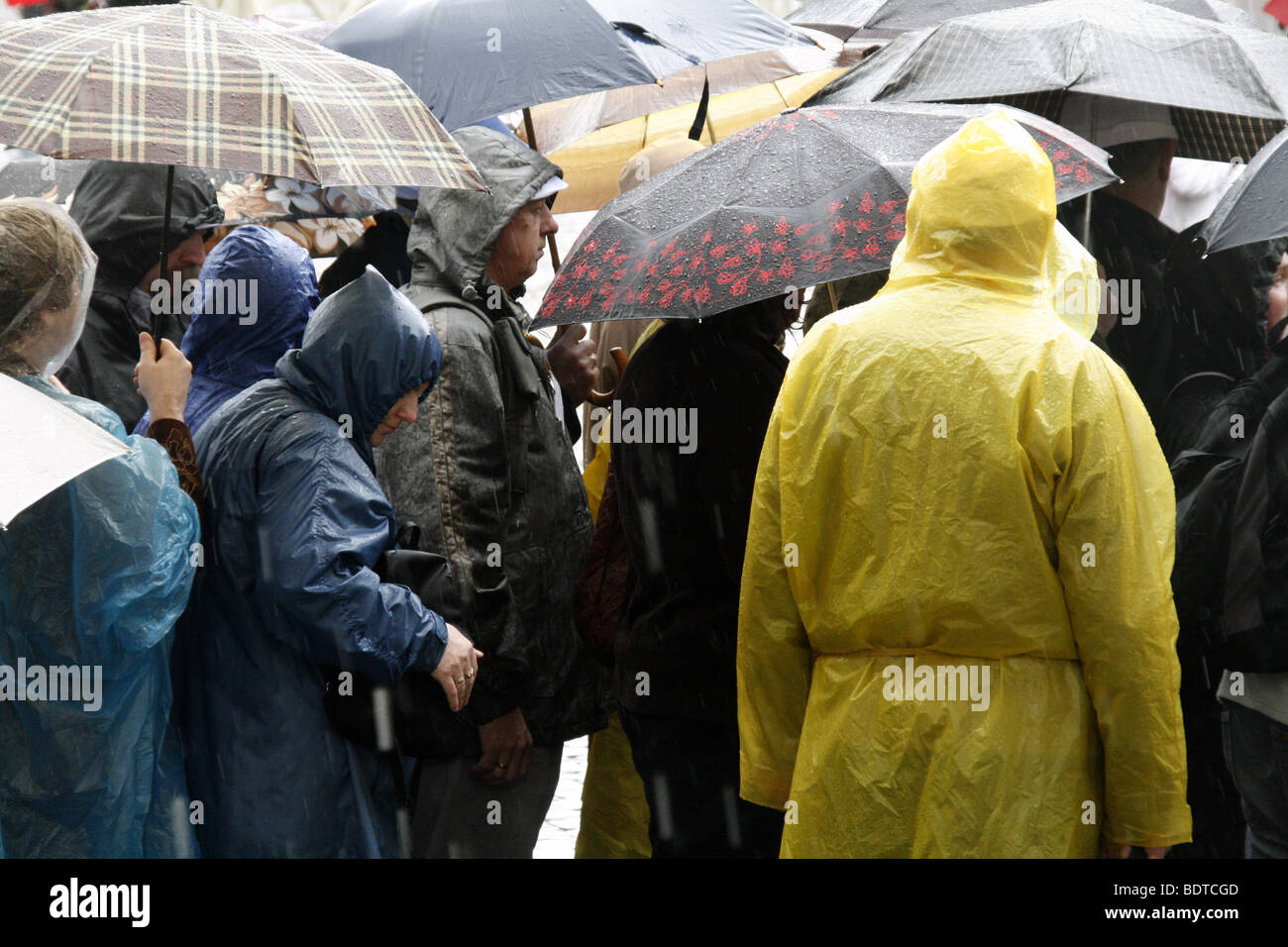 people with umbrellas in heavy rain in city town Stock Photo - Alamy