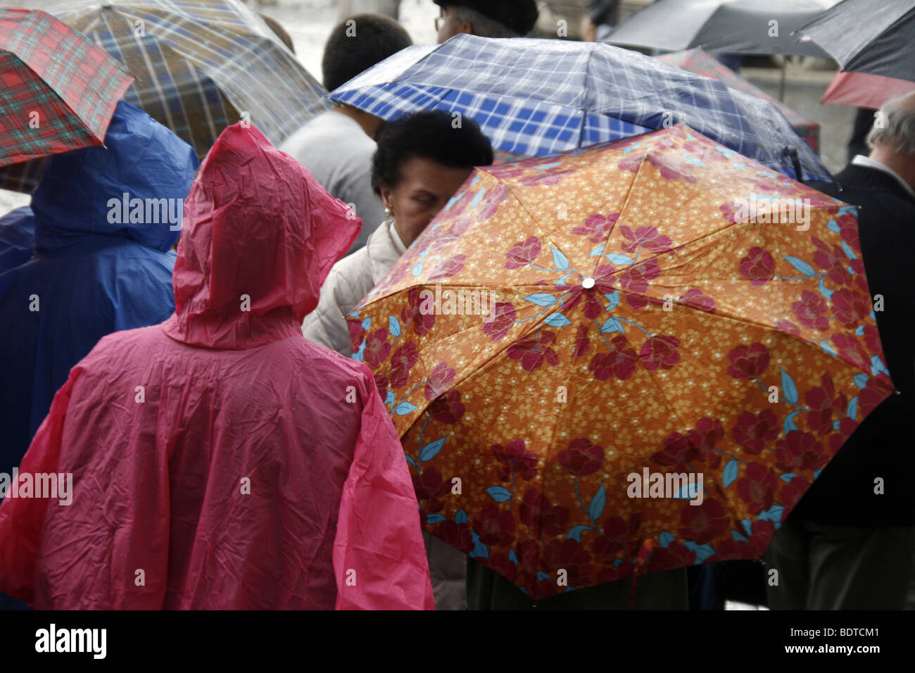 people with umbrellas in heavy rain in city town Stock Photo - Alamy