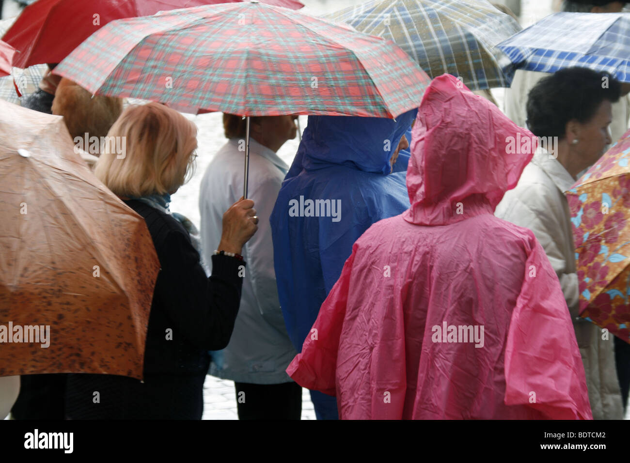 people with umbrellas in heavy rain in city town Stock Photo - Alamy