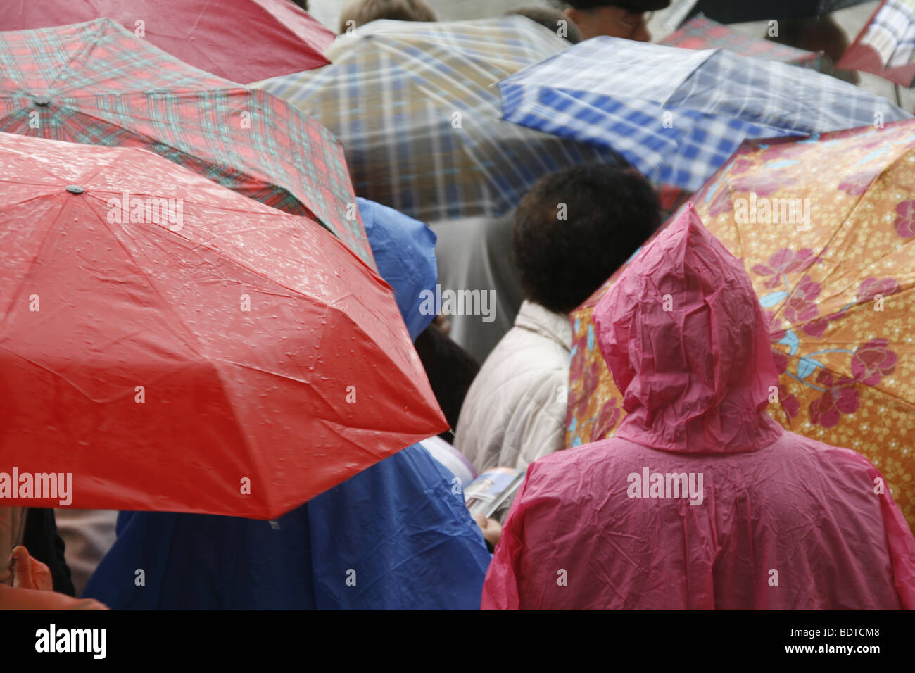 people with umbrellas in heavy rain in city town Stock Photo - Alamy
