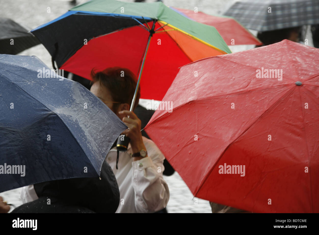 people with umbrellas in heavy rain in city town Stock Photo - Alamy