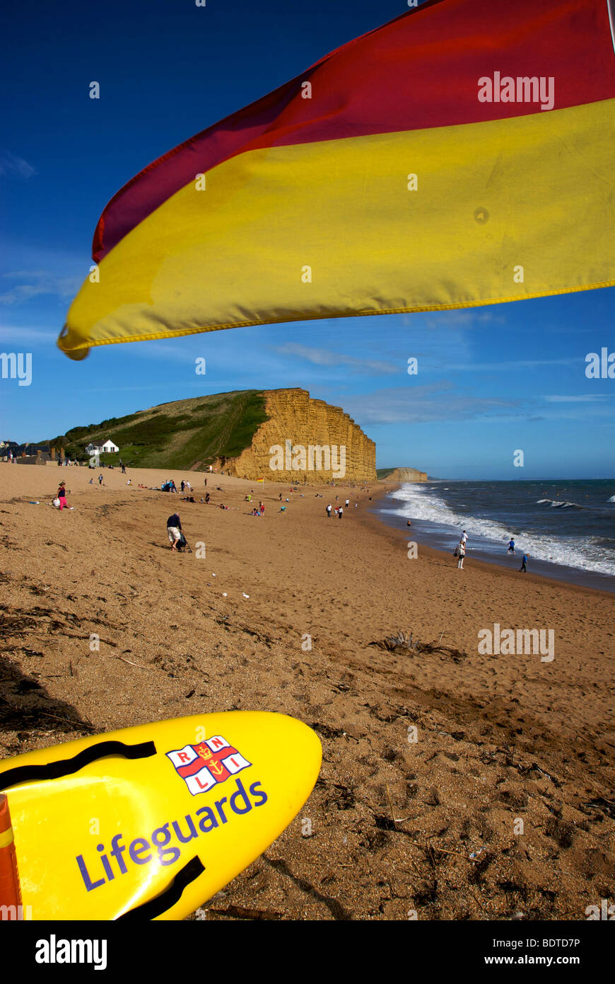 West Bay Dorset UK Cliffs Beach Sea Lifeguards RNLI Flag Stock Photo ...