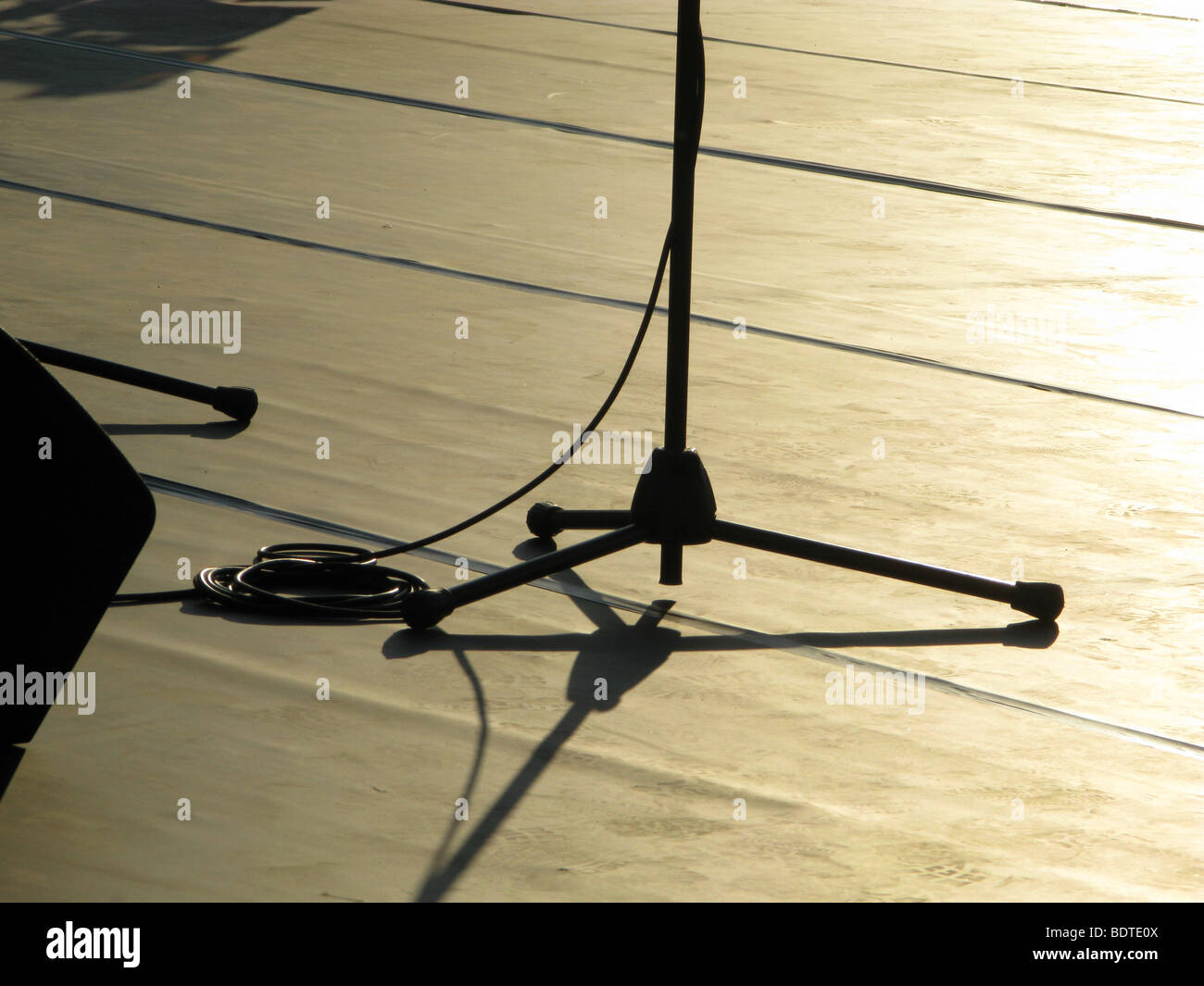 microphone stand on stage in sun outdoors Stock Photo - Alamy