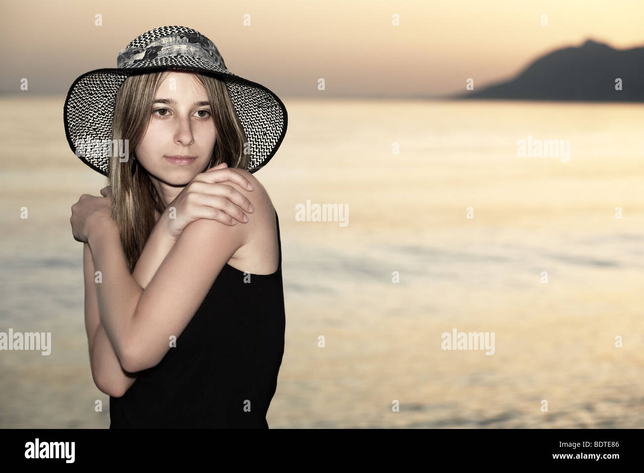 Portrait of a young woman by the sunset Stock Photo - Alamy