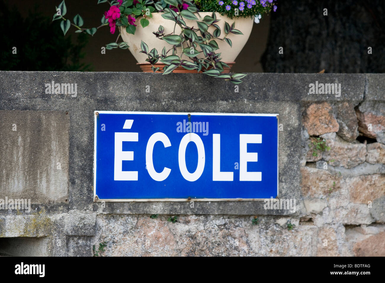 French sign for school on a village wall in France Stock Photo - Alamy
