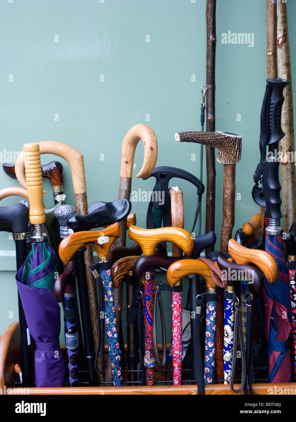 Colourful walking sticks and umbrellas on display outside a shop Stock ...