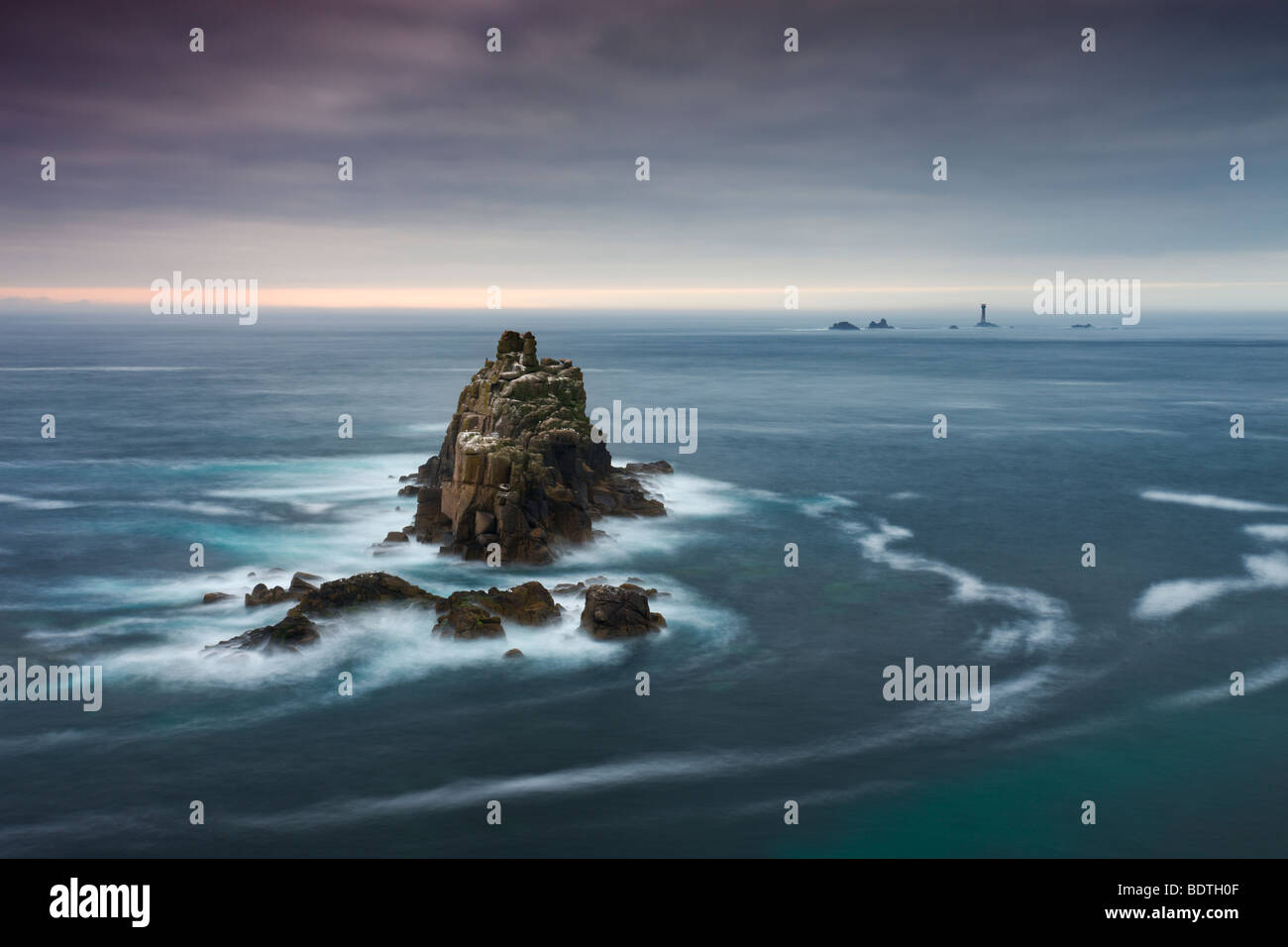 The Armed Knight rock stack and Longships Lighthouse off the coast at ...