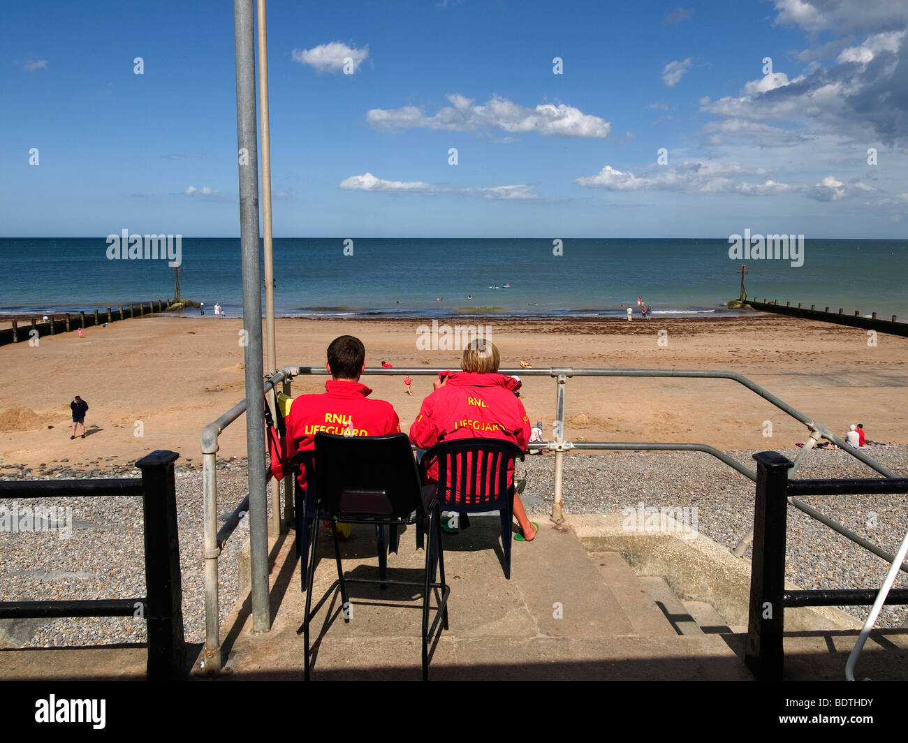 RNLI Beach lifeguards keeping watch on a sunny day in Sheringham ...